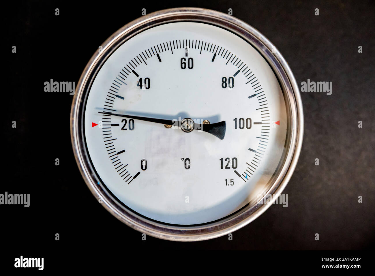 Close view of small white industrial barometer on black background ...