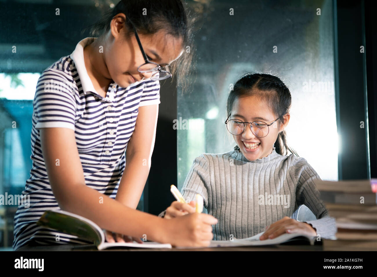 two asian student reading a school book with happiness emotion Stock ...