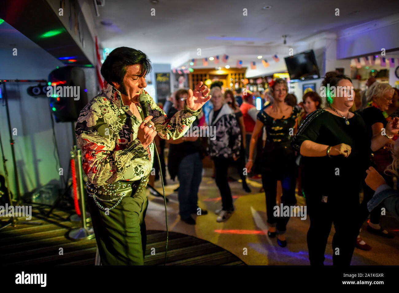 People dance to an Elvis performer inside a pub at the annual Porthcawl ...