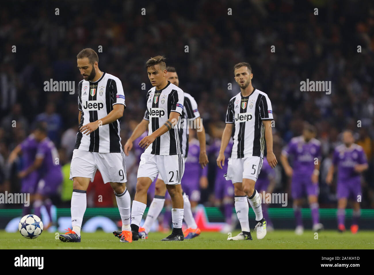 Dejected Juventus players make their way back to the halfway line after ...