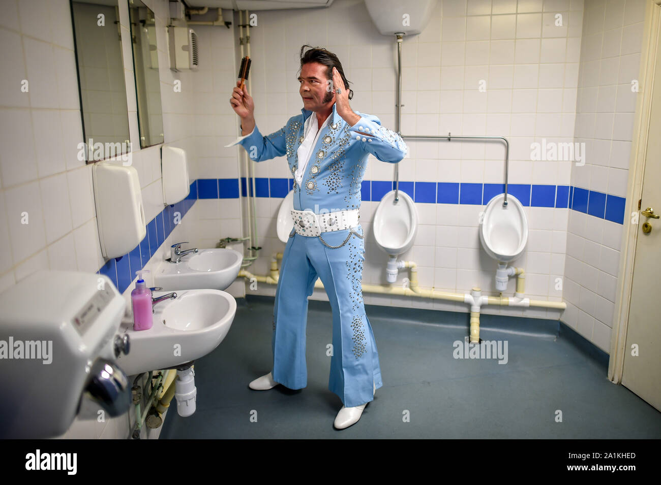 An Elvis finalises his hair inside the toilets in the Grand Pavillion ...