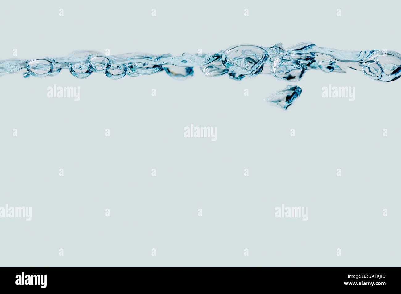 Lateral studio shot under the water surface of hanging bubbles in front ...