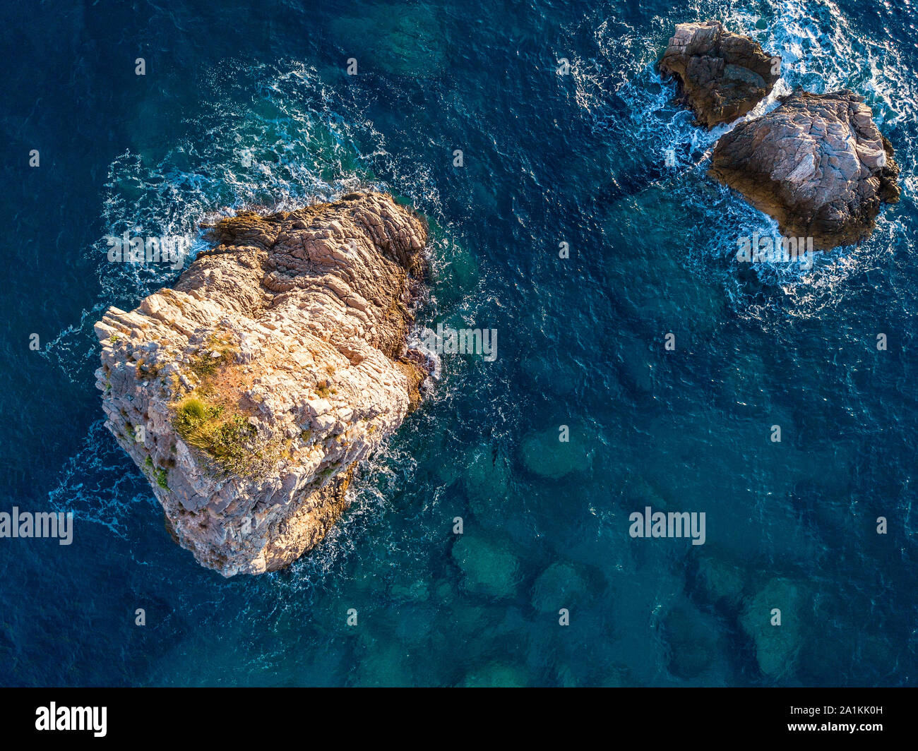 Aerial view of a seabed with rocks emerging from the sea, seabed seen ...
