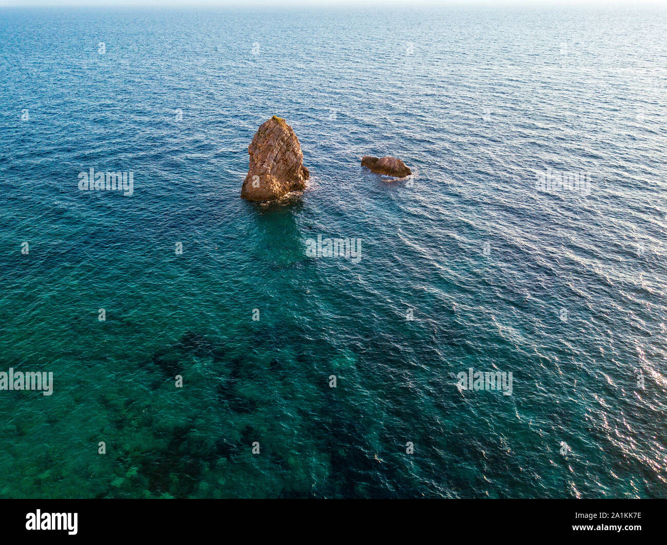 Aerial view of a seabed with rocks emerging from the sea, seabed seen ...