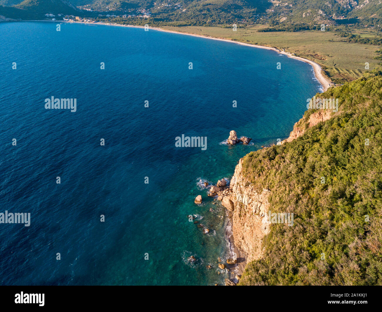 Aerial view of Buljarica promontory, steep cliff on the coast lapped by ...