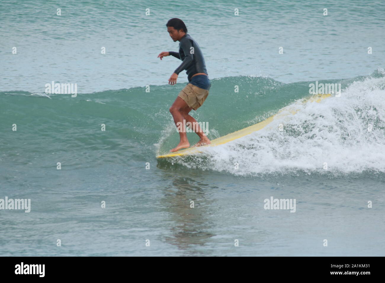 Kuta Beach, Bali 2019. Local surfer spent the day with wave Stock Photo ...