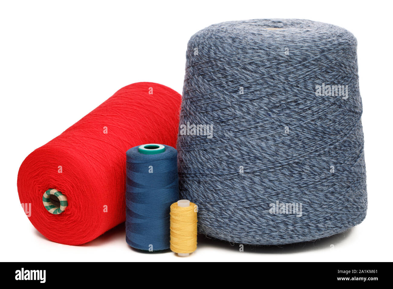 Cones and spools of synthetic or cotton threads on white background ...