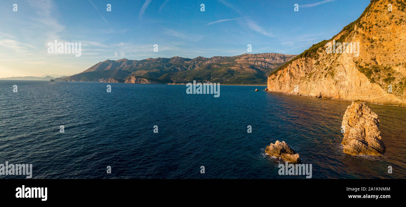 Aerial view of Buljarica promontory, steep cliff on the coast lapped by ...