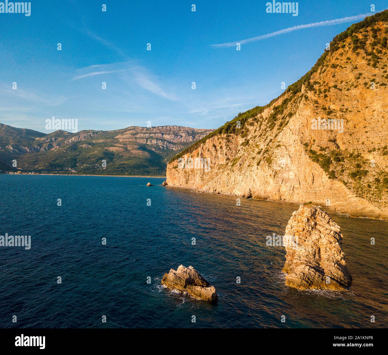 Aerial view of Buljarica promontory, steep cliff on the coast lapped by ...