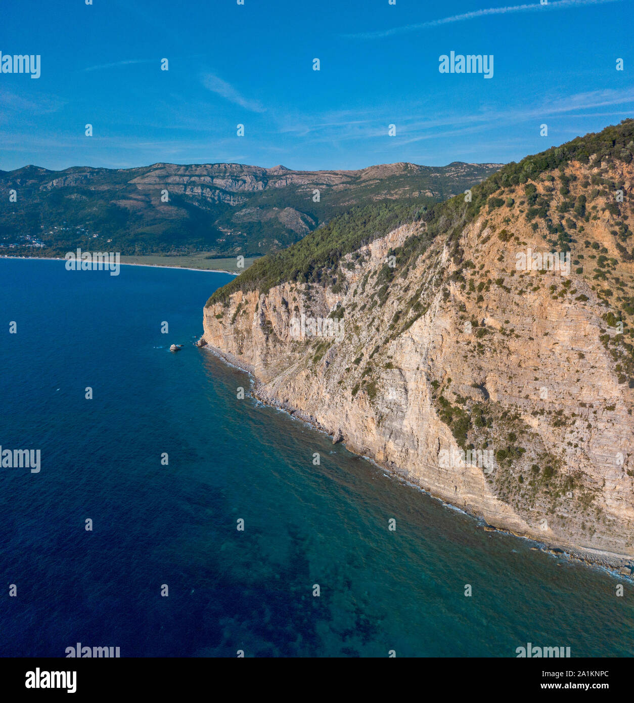 Aerial view of Buljarica promontory, steep cliff on the coast lapped by ...
