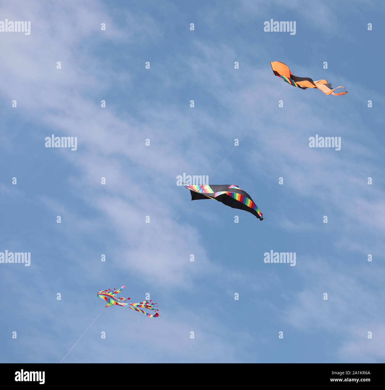 three kite flying on the blue sky in summer Stock Photo - Alamy