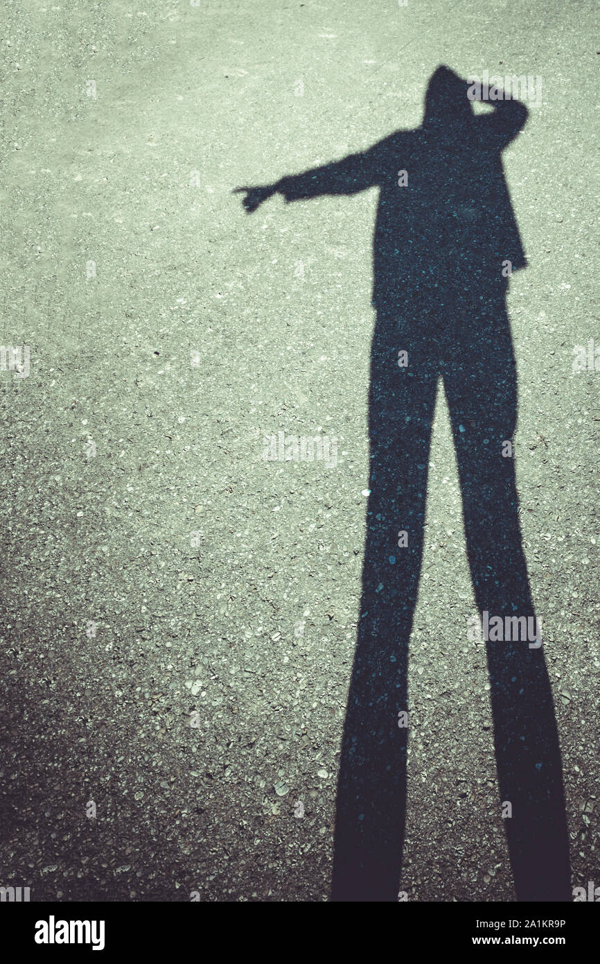Shadow of a woman pointing Stock Photo - Alamy