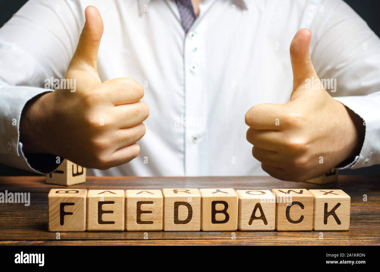 Wooden blocks with the word Feedback and hand up. The concept of the ...