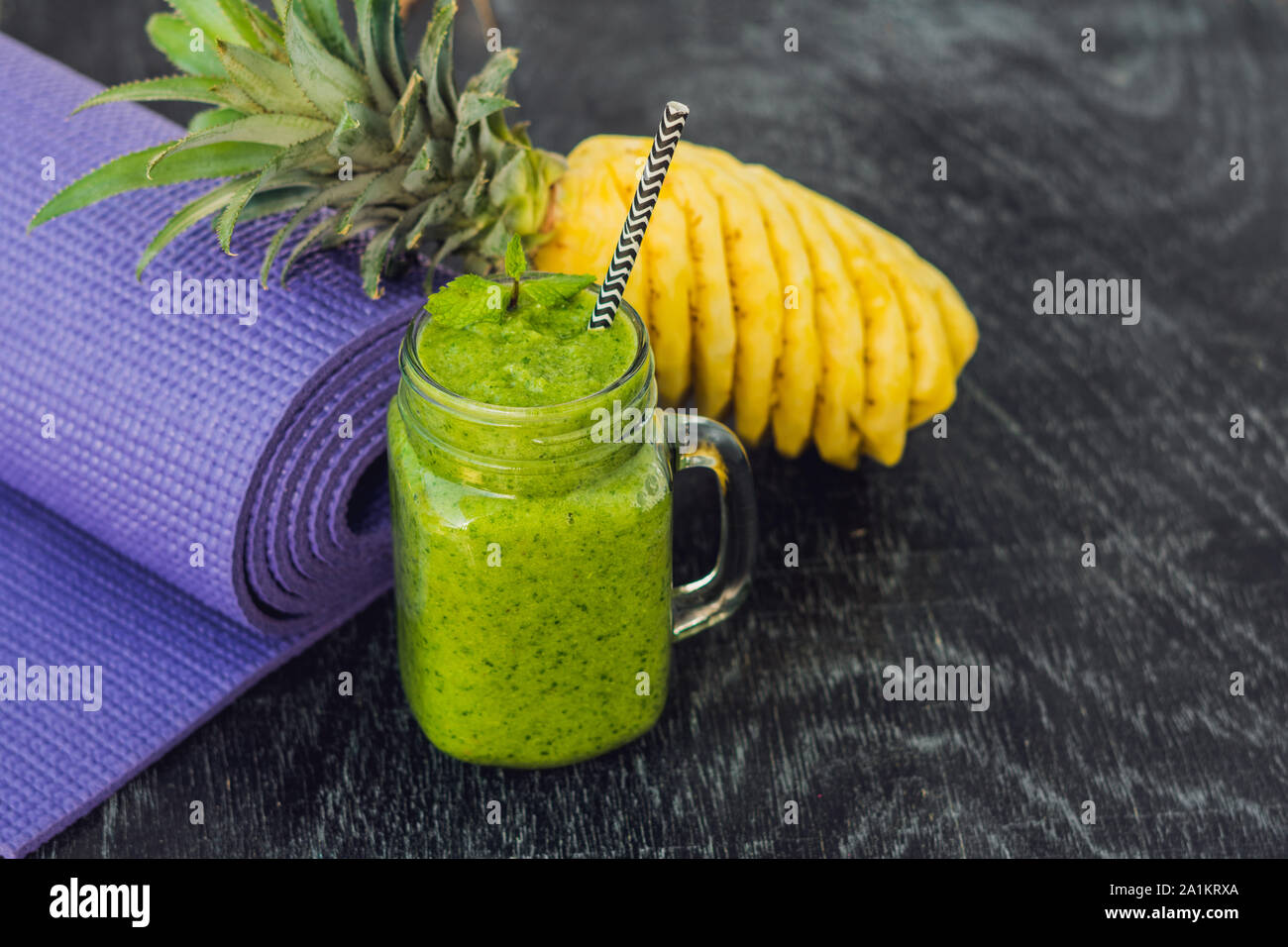 Green smoothies made of spinach and pineapple and a yoga mat. Healthy ...