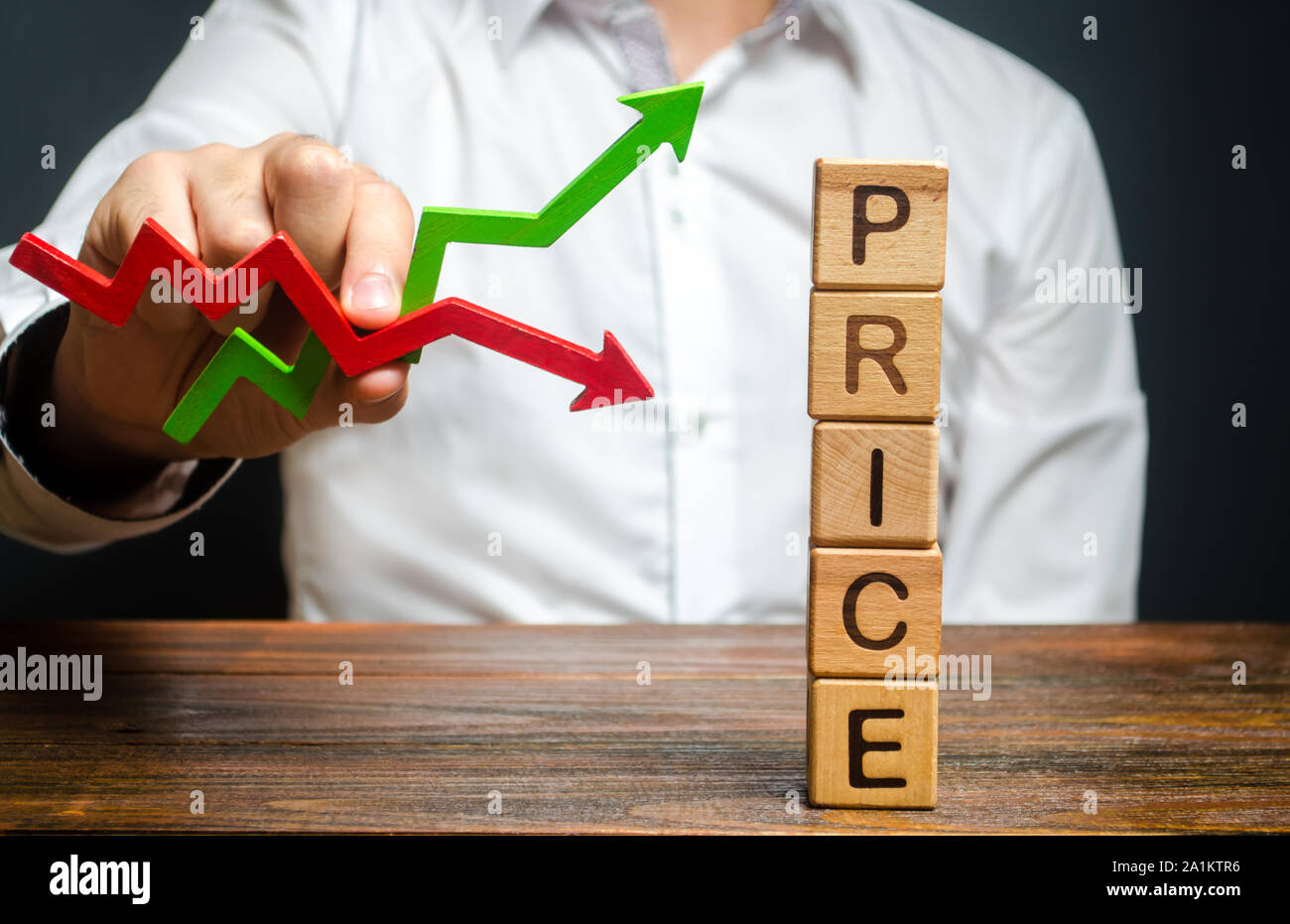 A man holds a red and green arrow and predicts a price change. Price ...