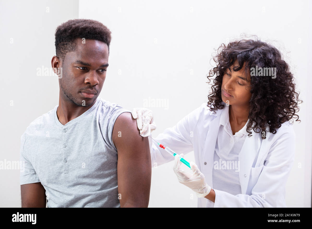 Nurse giving male patient injection hi-res stock photography and images ...