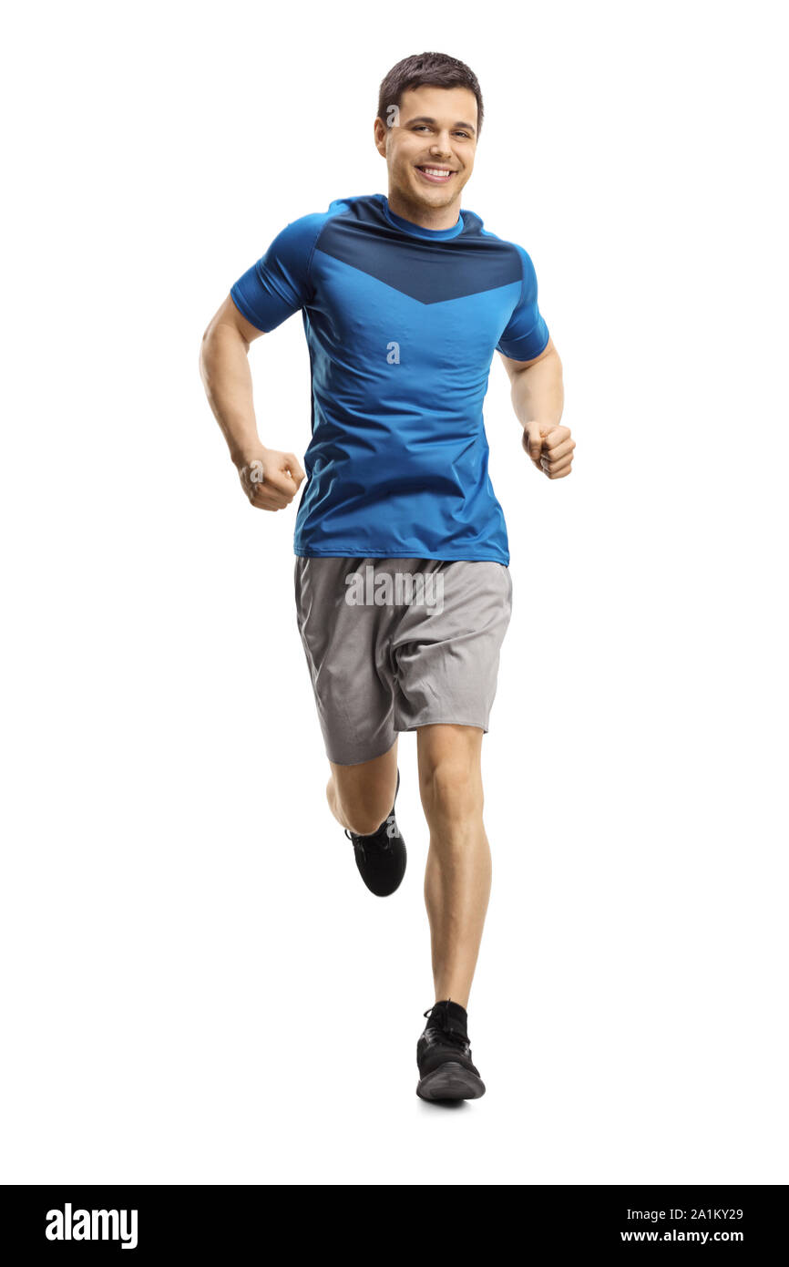 Full length portrait of a young man jogging towards the camera isolated ...