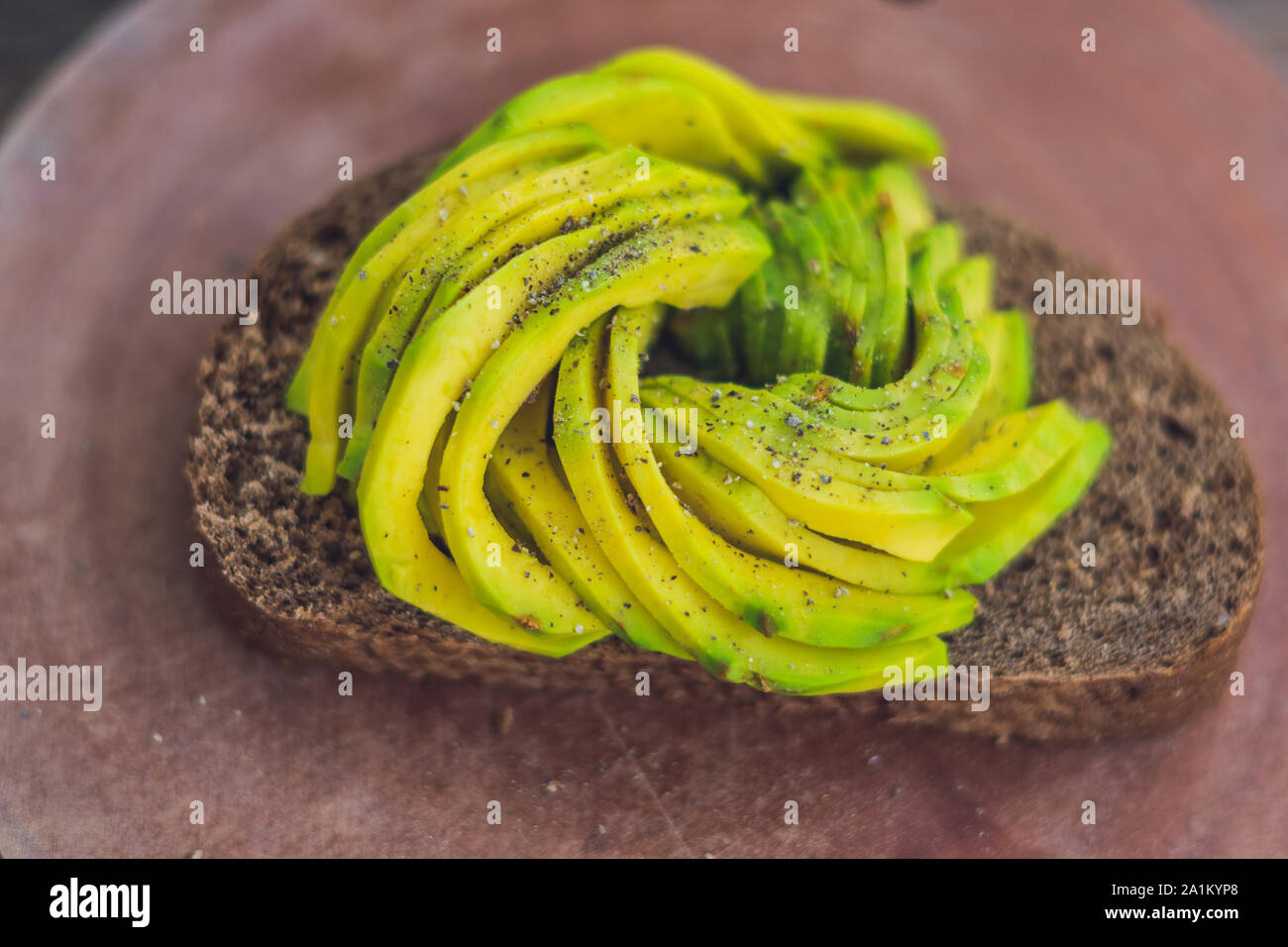 Avocado sandwich on dark rye bread made with fresh sliced avocados ...