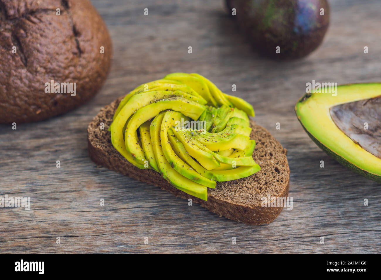 Avocado sandwich on dark rye bread made with fresh sliced avocados ...