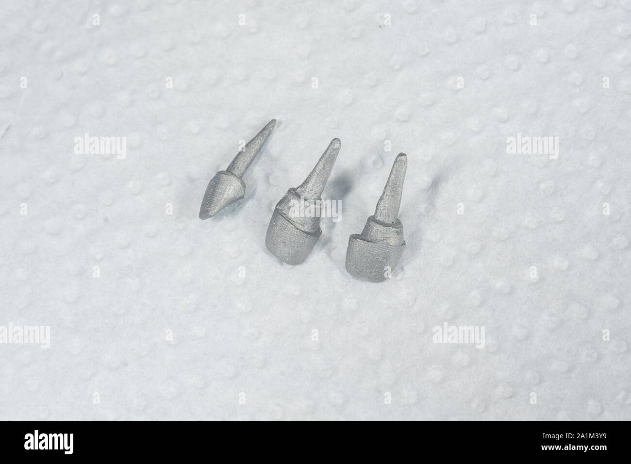 metal cast pin of a human tooth on a gypsum model close-up in dental ...