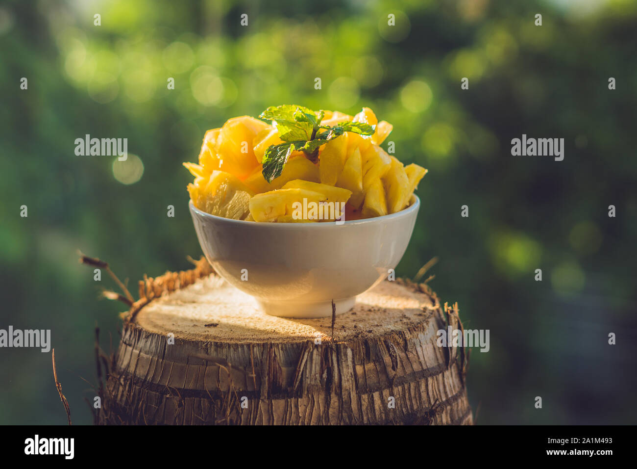 pieces of pineapple on a background of greenery Stock Photo - Alamy