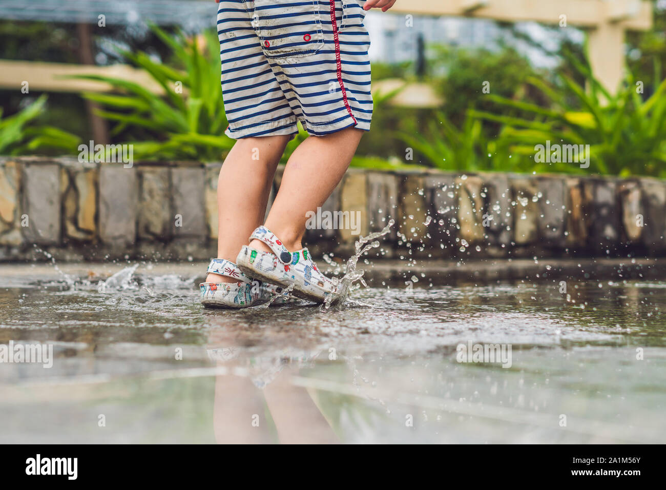 Kid Jump Puddle High Resolution Stock Photography and Images - Alamy