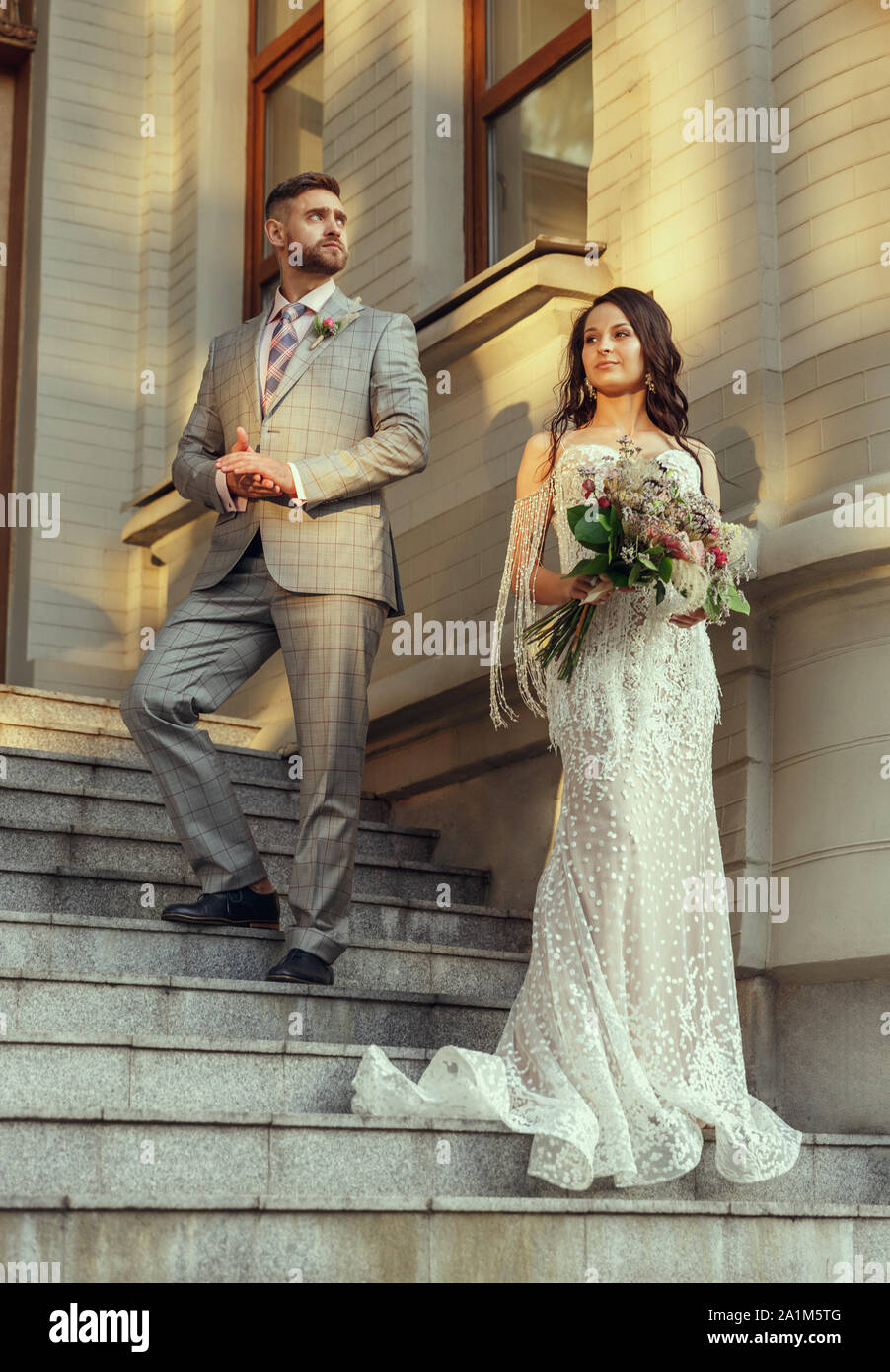 Caucasian romantic young couple celebrating their marriage in city ...