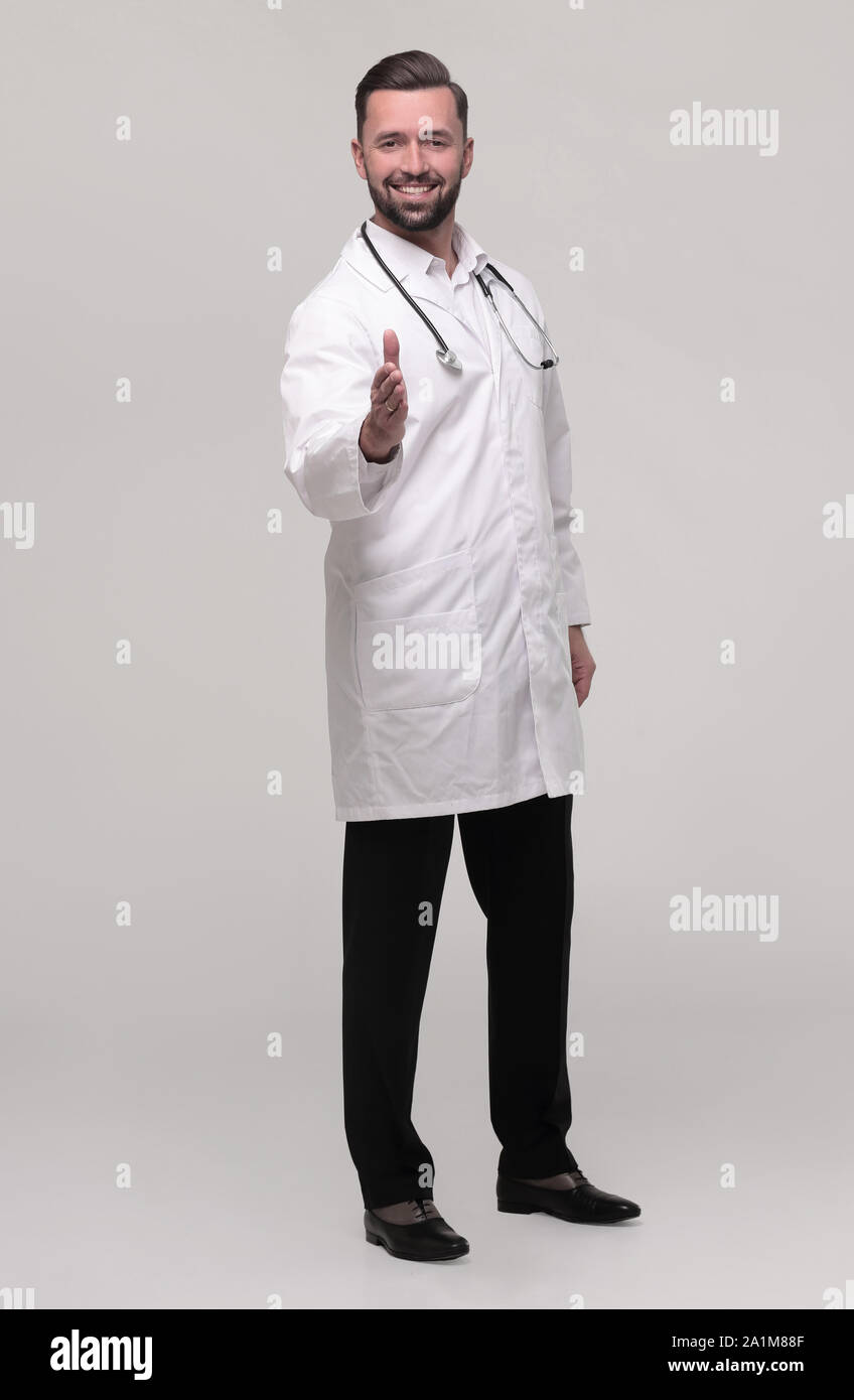 in full growth. the medical doctor holding out his hand for a handshake ...