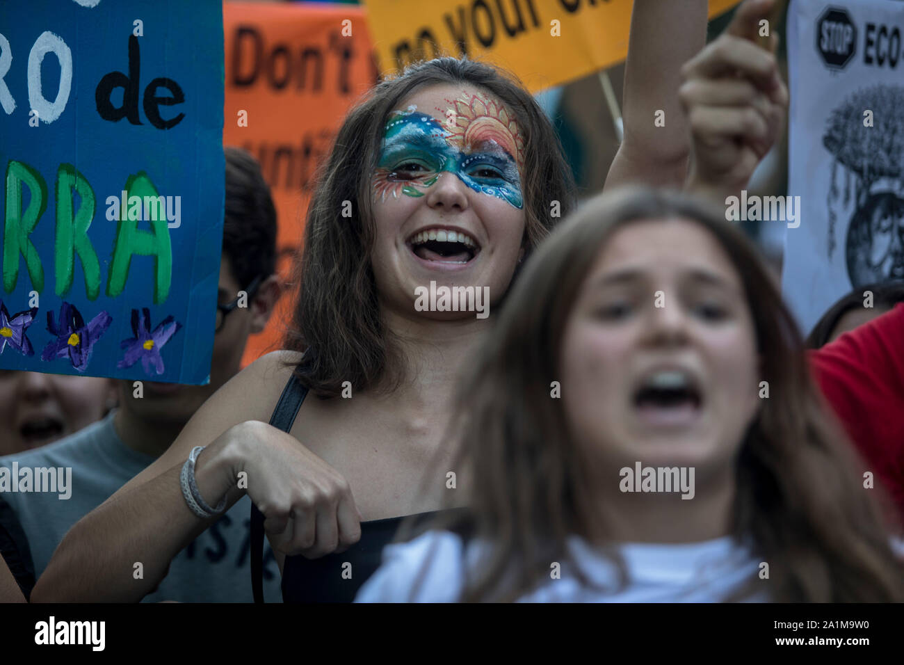 A woman with face paintings shouting slogans during the Climate Strike ...