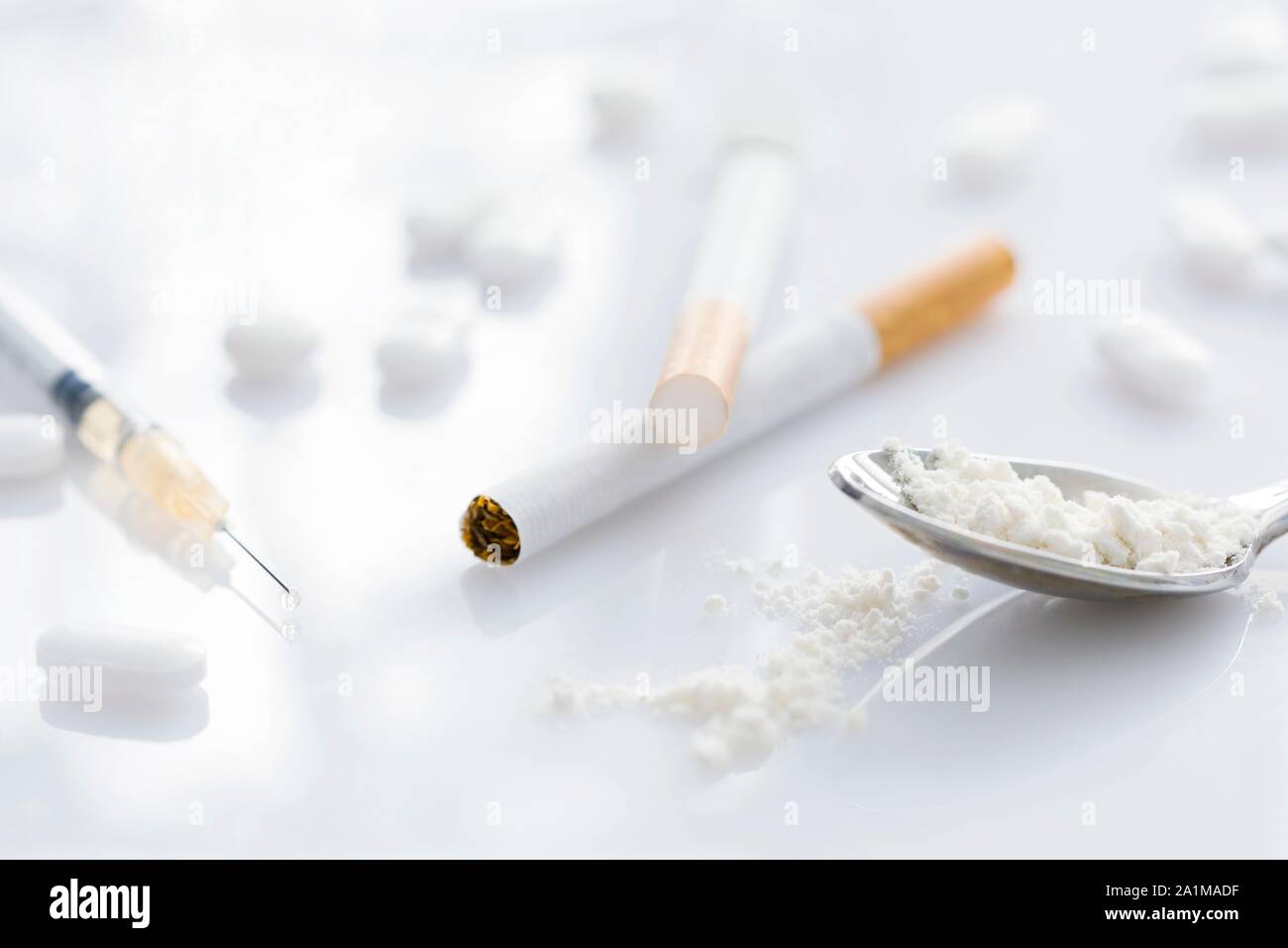 Conceptual image of drug addiction. Cigarettes, painkillers and heroin ...