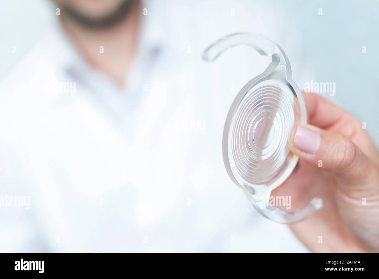 Model ophthalmic lens. Optometrist holding a model lens Stock Photo - Alamy