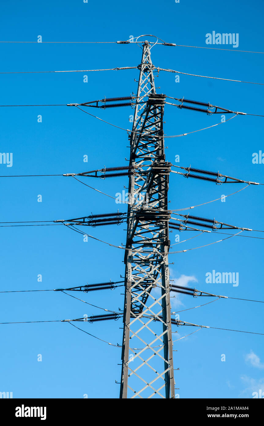 lattice tower of electric overhead powerline with cables and insulators ...