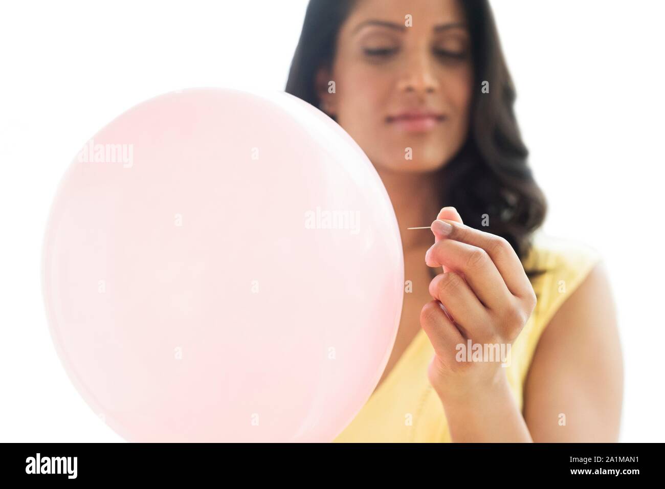 Woman popping pink balloon. Conceptual image for bloated stomach Stock ...