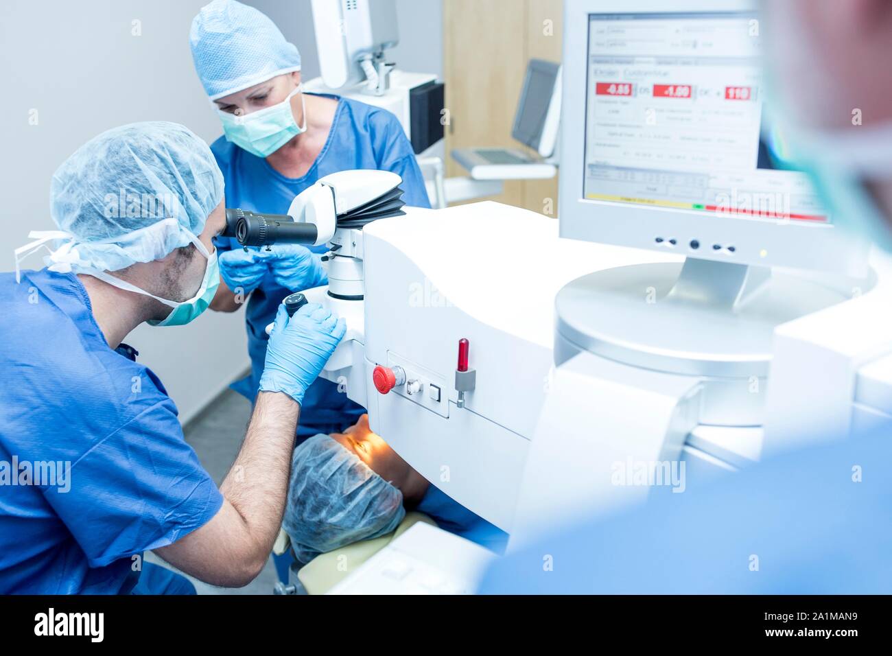 Surgical team performing laser eye surgery Stock Photo - Alamy