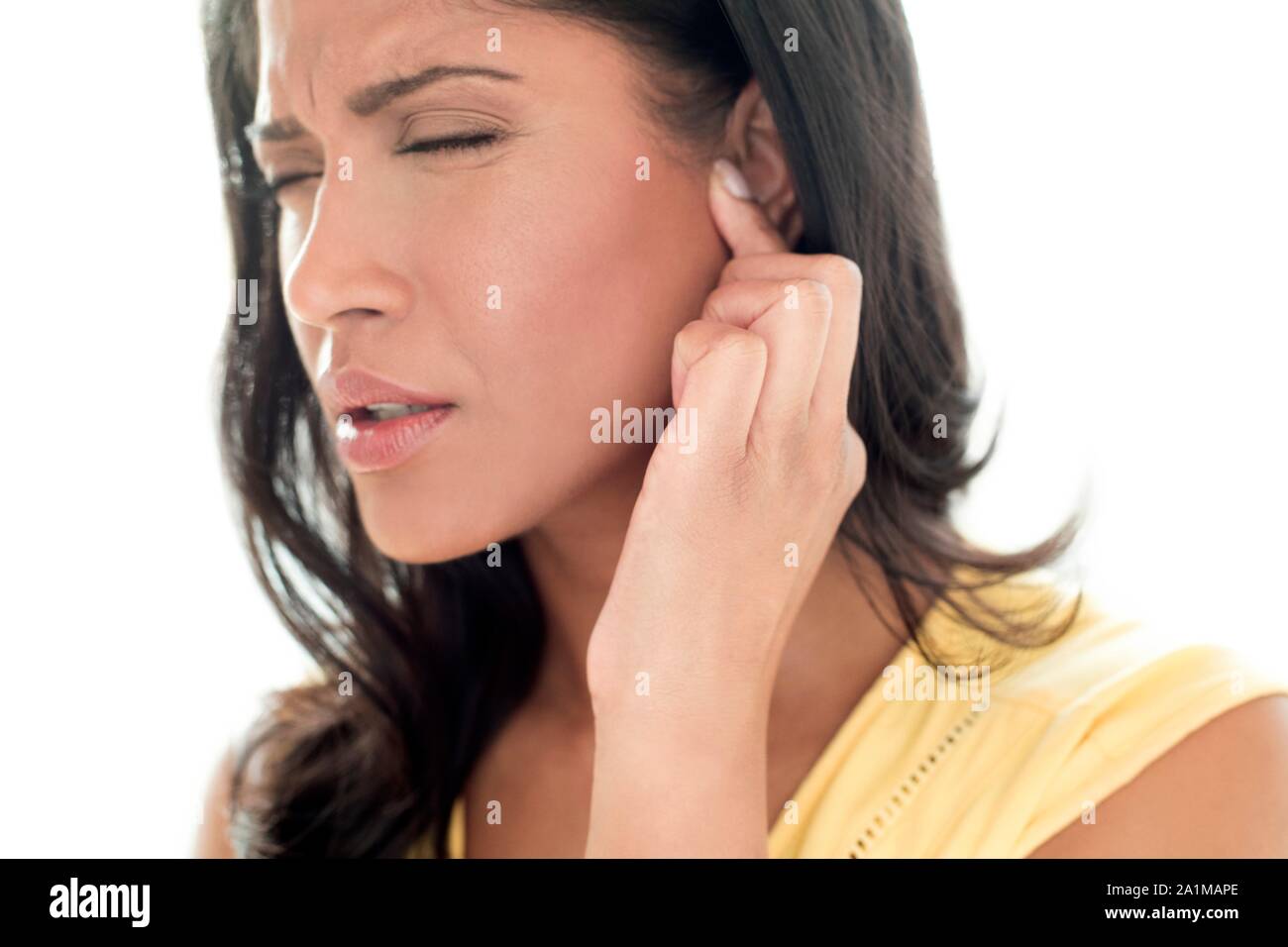 Woman touching ear in pain Stock Photo - Alamy