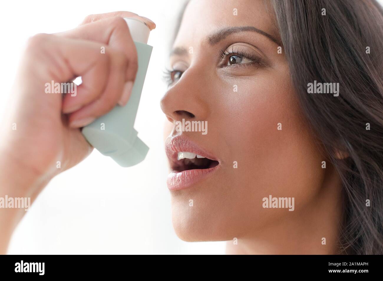Woman using asthma inhaler Stock Photo - Alamy