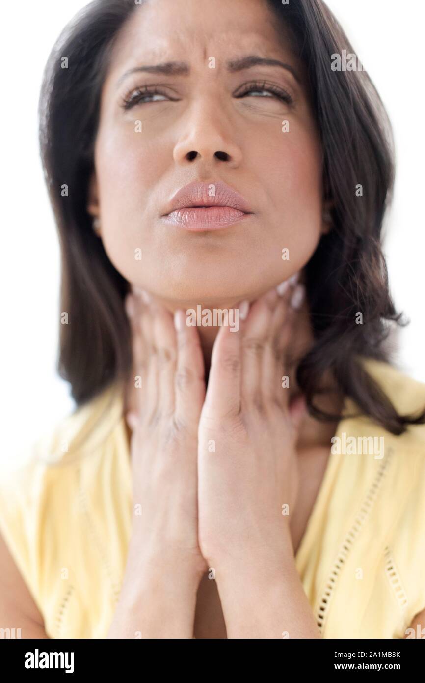 Woman touching her neck in pain Stock Photo - Alamy