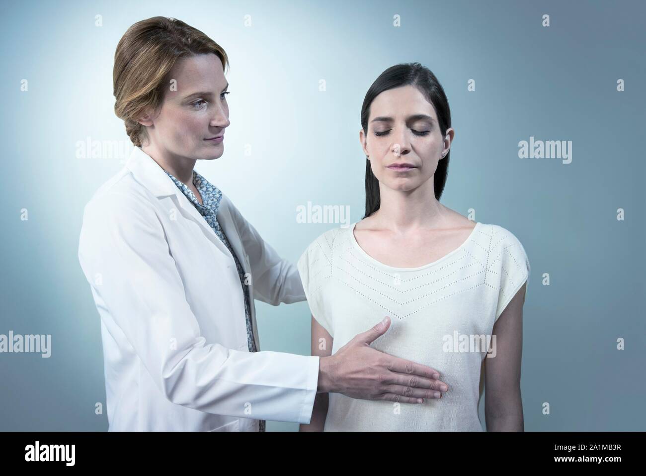 Neurologist performing the Romberg test on a female patient to test ...