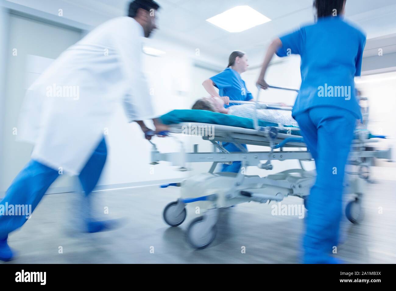 Hospital emergency, medical staff pushing patient on gurney Stock Photo ...
