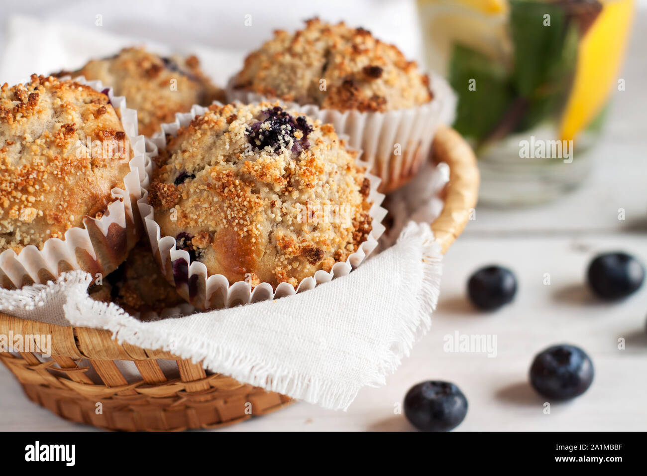 Homemade blueberry muffins in wicker basket on white wooden table Stock ...