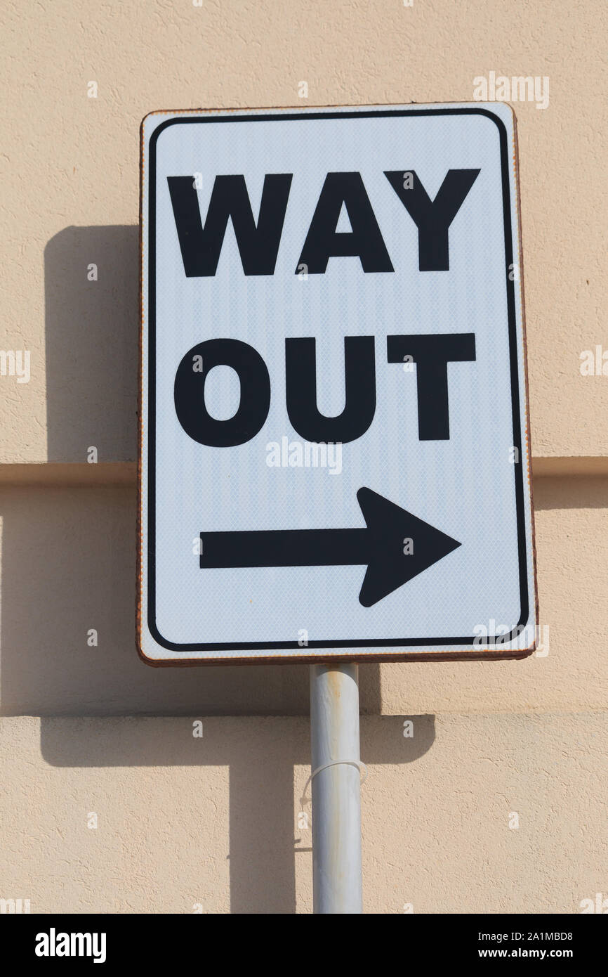 Road sign WAY OUT. The Wall in background Stock Photo - Alamy