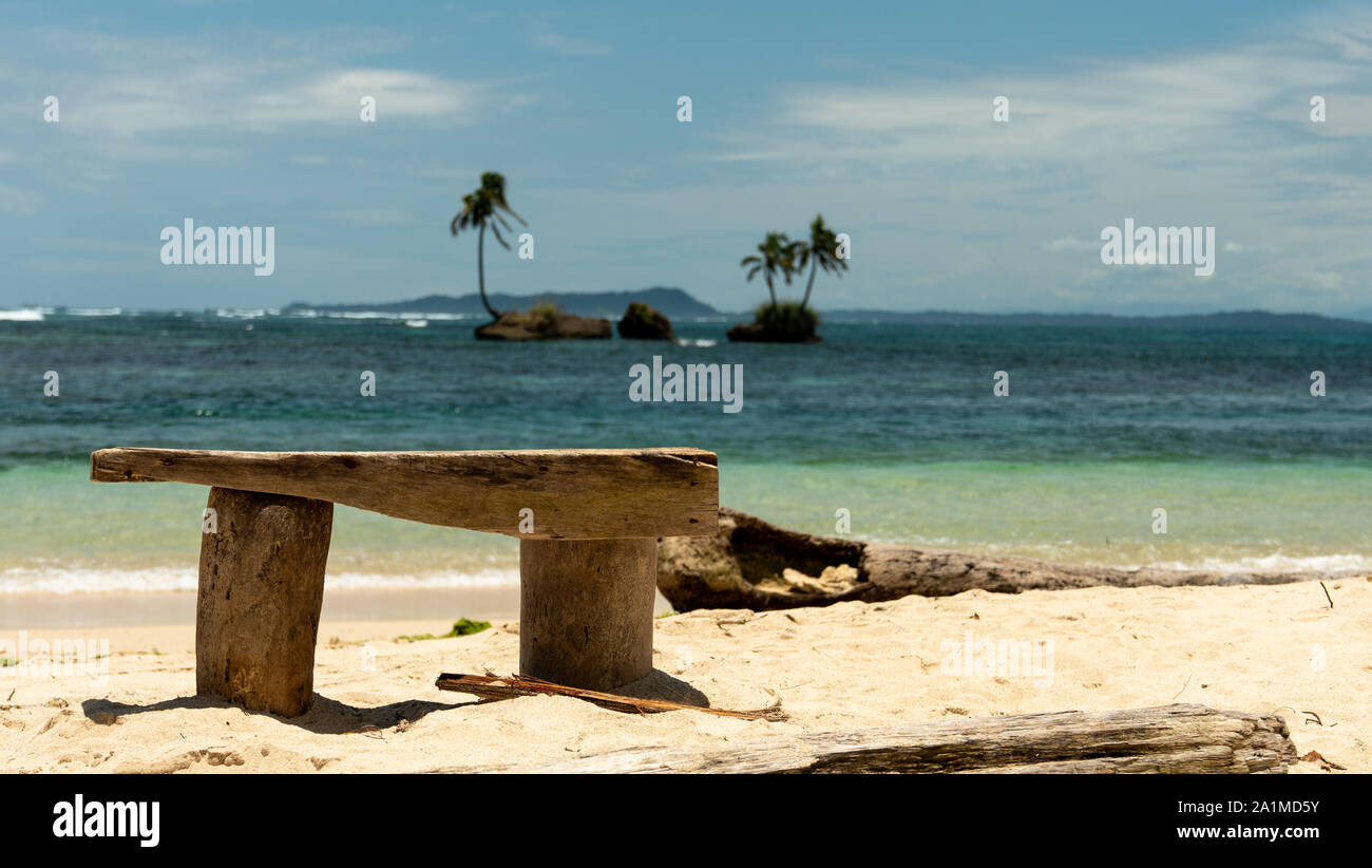 Rustic wooden bench on a sandy tropical beach Stock Photo - Alamy