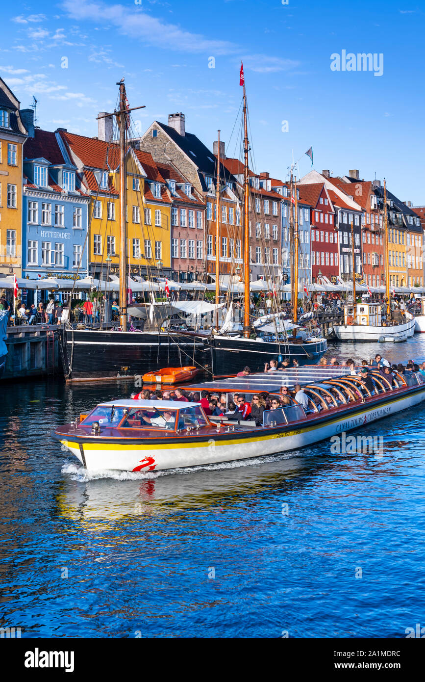 Colorful townhouses along a canal in the Nyhavn district of Copenhagen ...