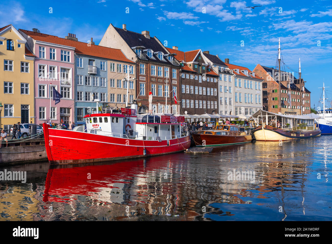 Colorful townhouses along a canal in the Nyhavn district of Copenhagen ...