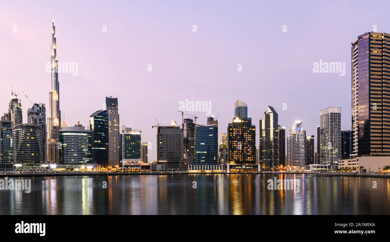 Stunning view of the illuminated Dubai skyline during sunset with tall ...