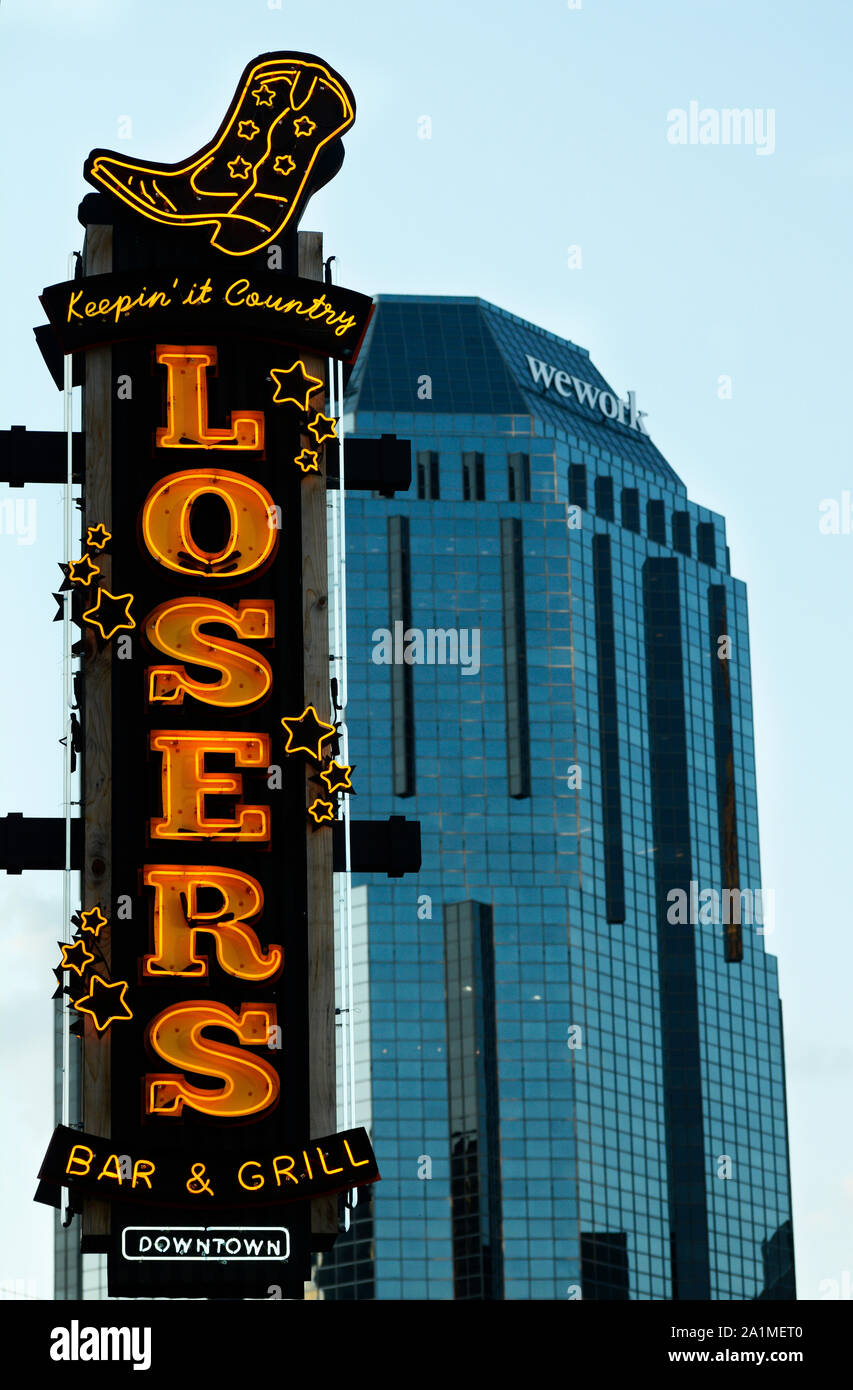 A country music bar's neon sign includes a cowboy boot in Nashville ...