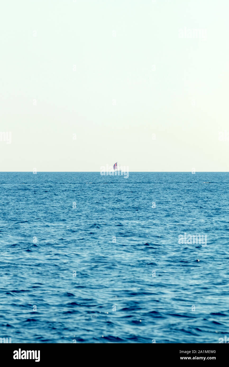Distant sail boat on the sea, Summer vacation Stock Photo - Alamy