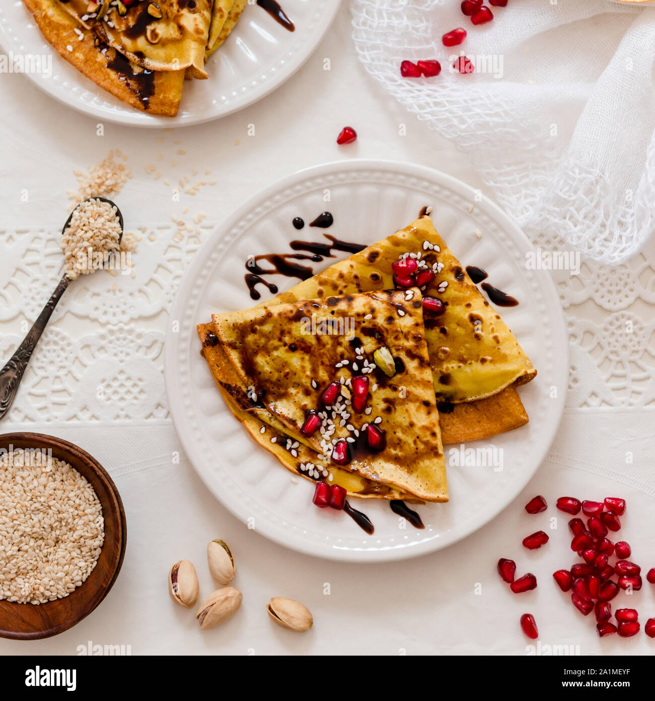 Thin Crepes with melted chocolate, sesame seeds, pomegranate and ...