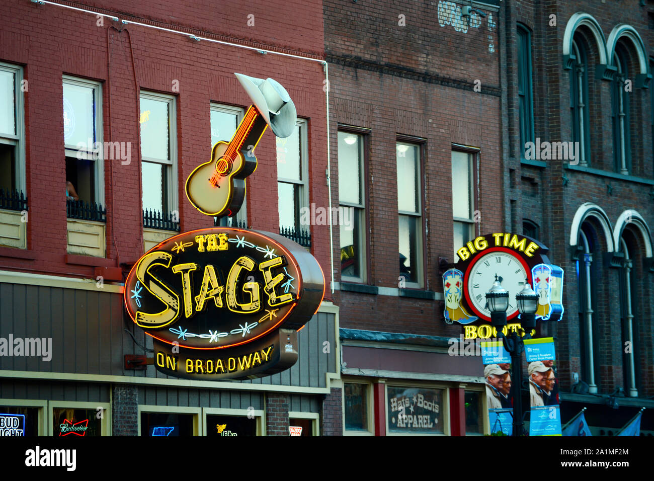 A neon sign in the shape of guitar and cowboy hat hangs over the ...