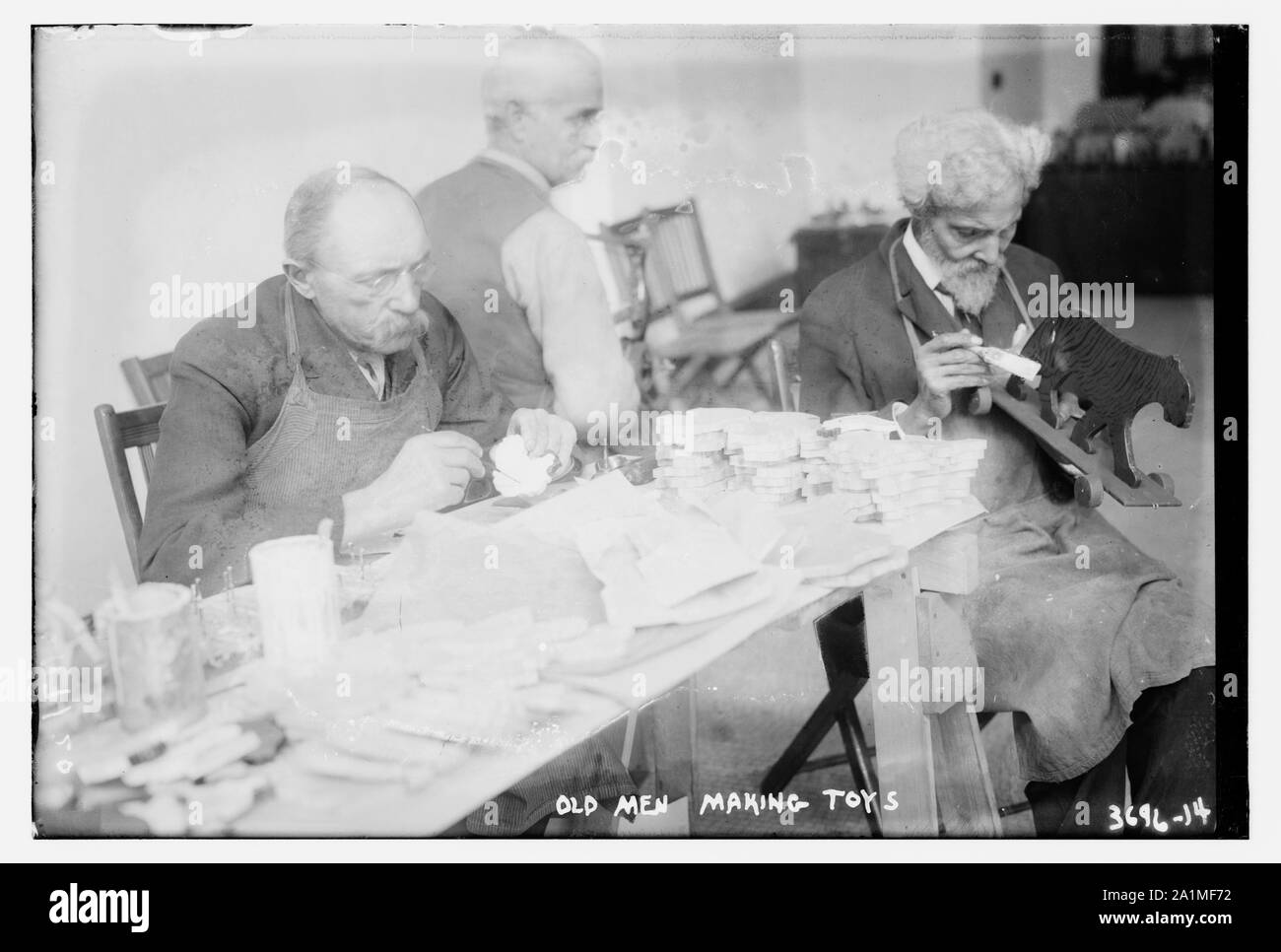 Old Men making toys Stock Photo - Alamy